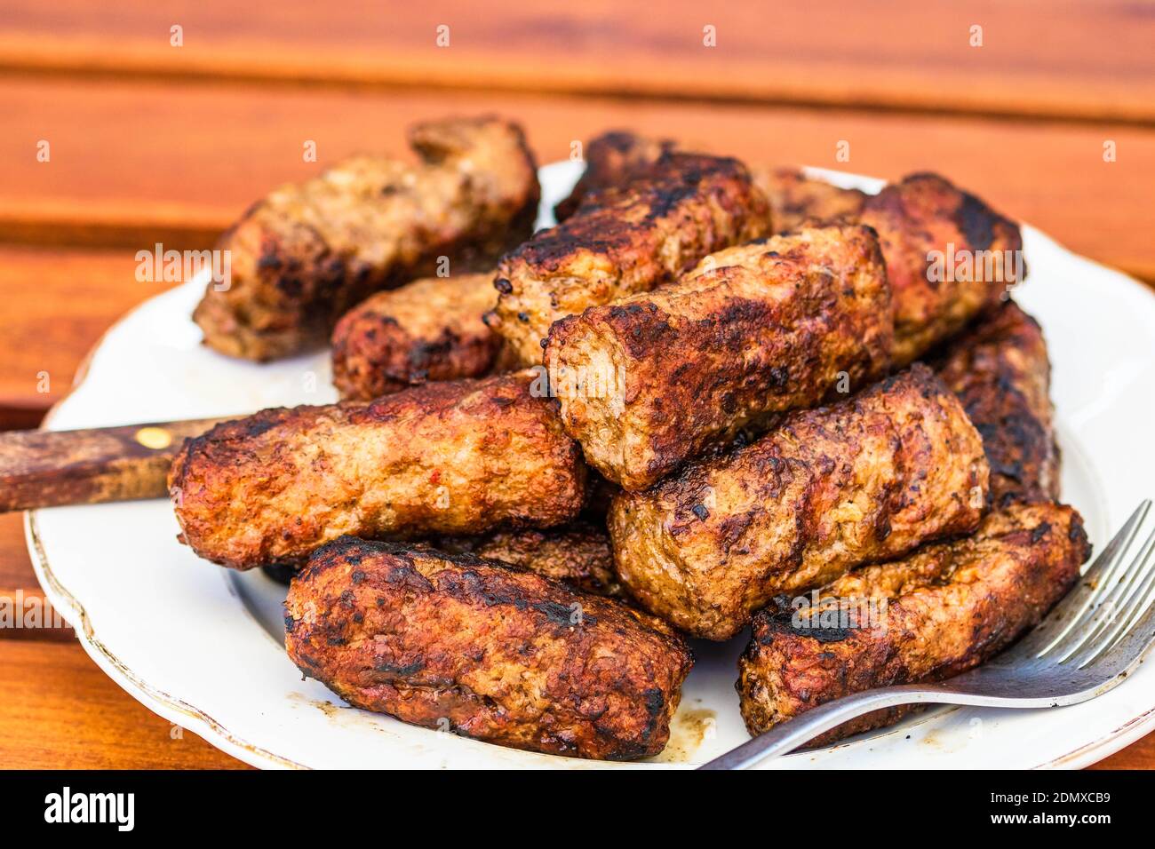 Meat rolls called mici or mititei on plate isolated Stock Photo - Alamy