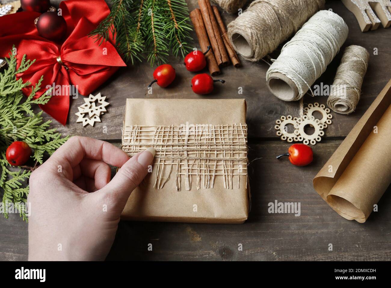 Woman shows how to beautifully pack Christmas presents. Step by step ...