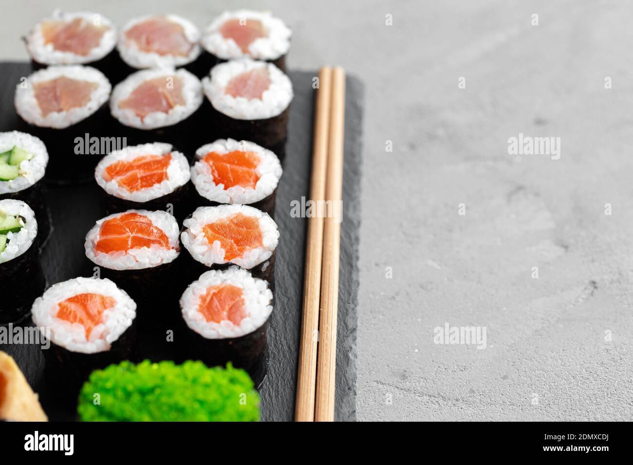 Maki sushi set served on black stone tray Stock Photo - Alamy