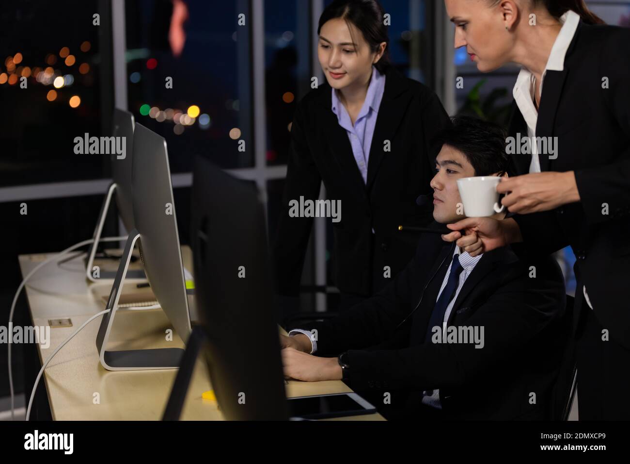 Business team working overtime late at night in call center office for ...