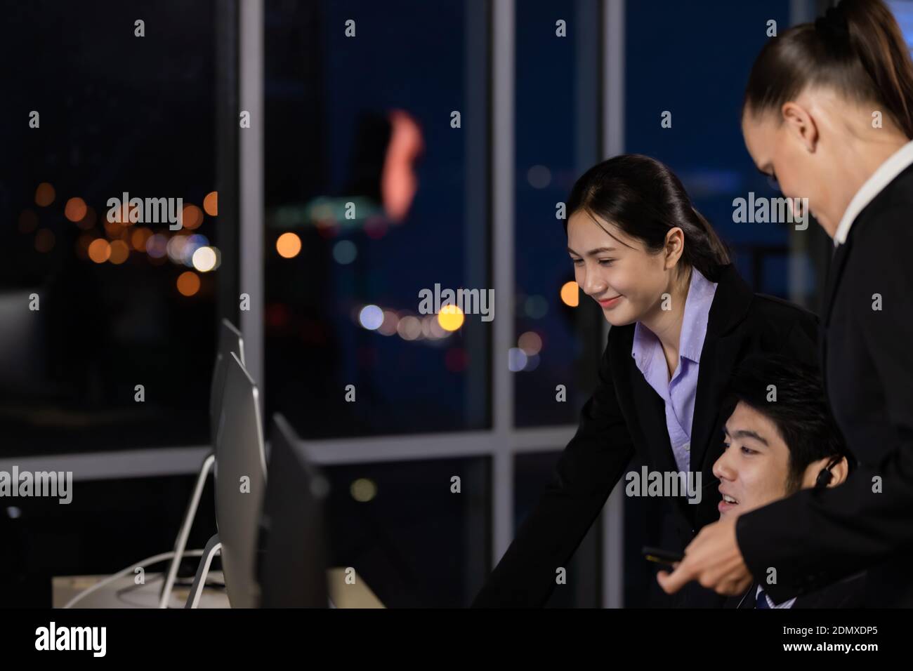 Business team working overtime late at night in call center office for ...