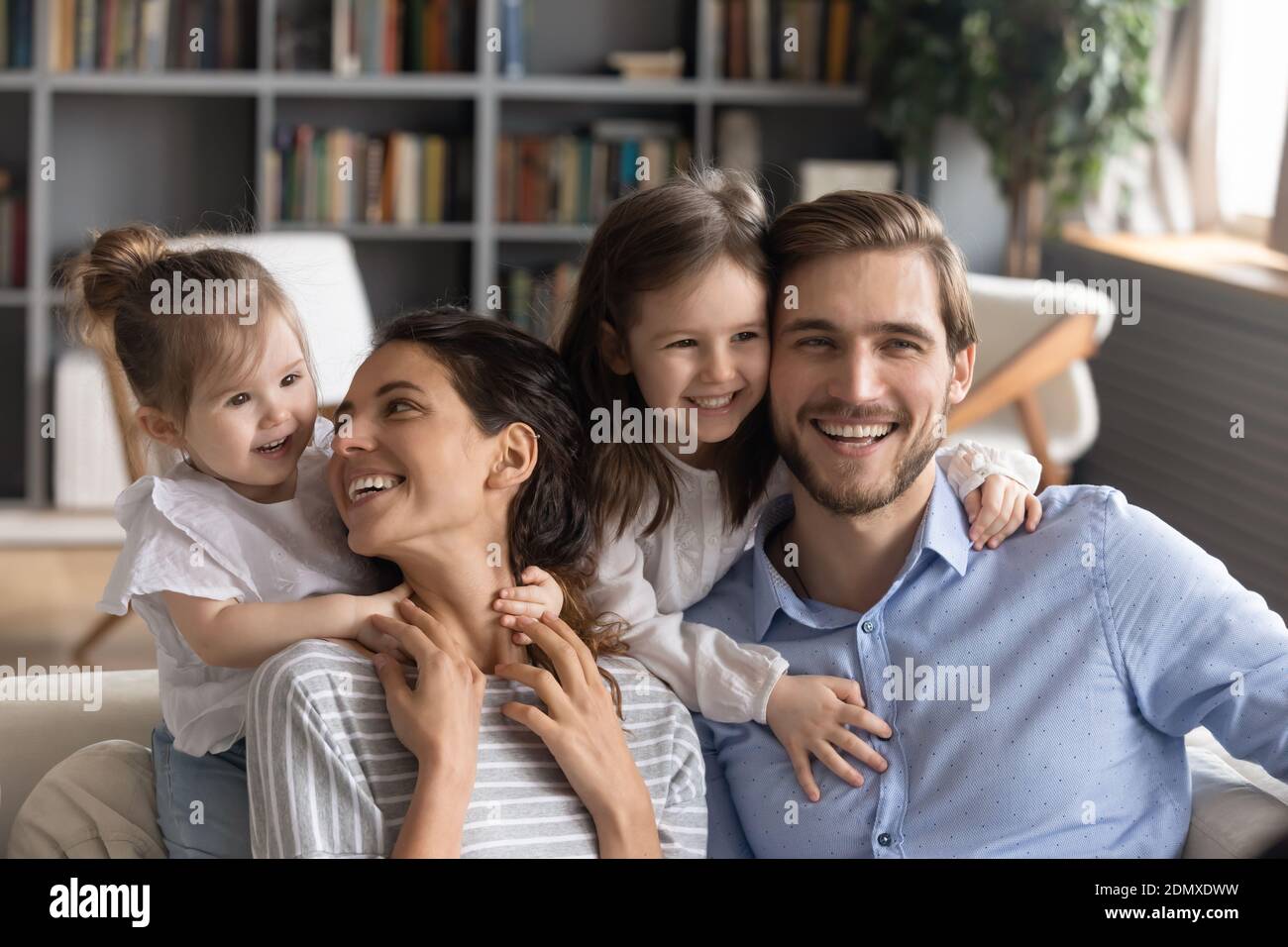 Smiling little children hug happy young parents Stock Photo - Alamy