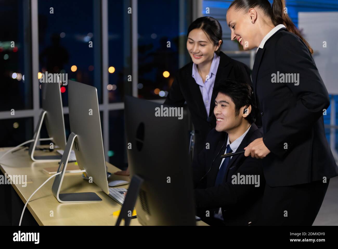 Business team working overtime late at night in call center office for ...