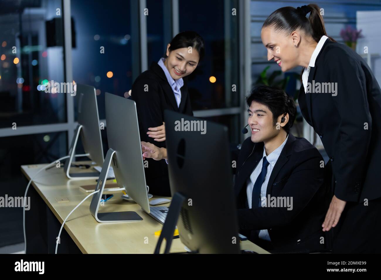 Business team working overtime late at night in call center office for ...