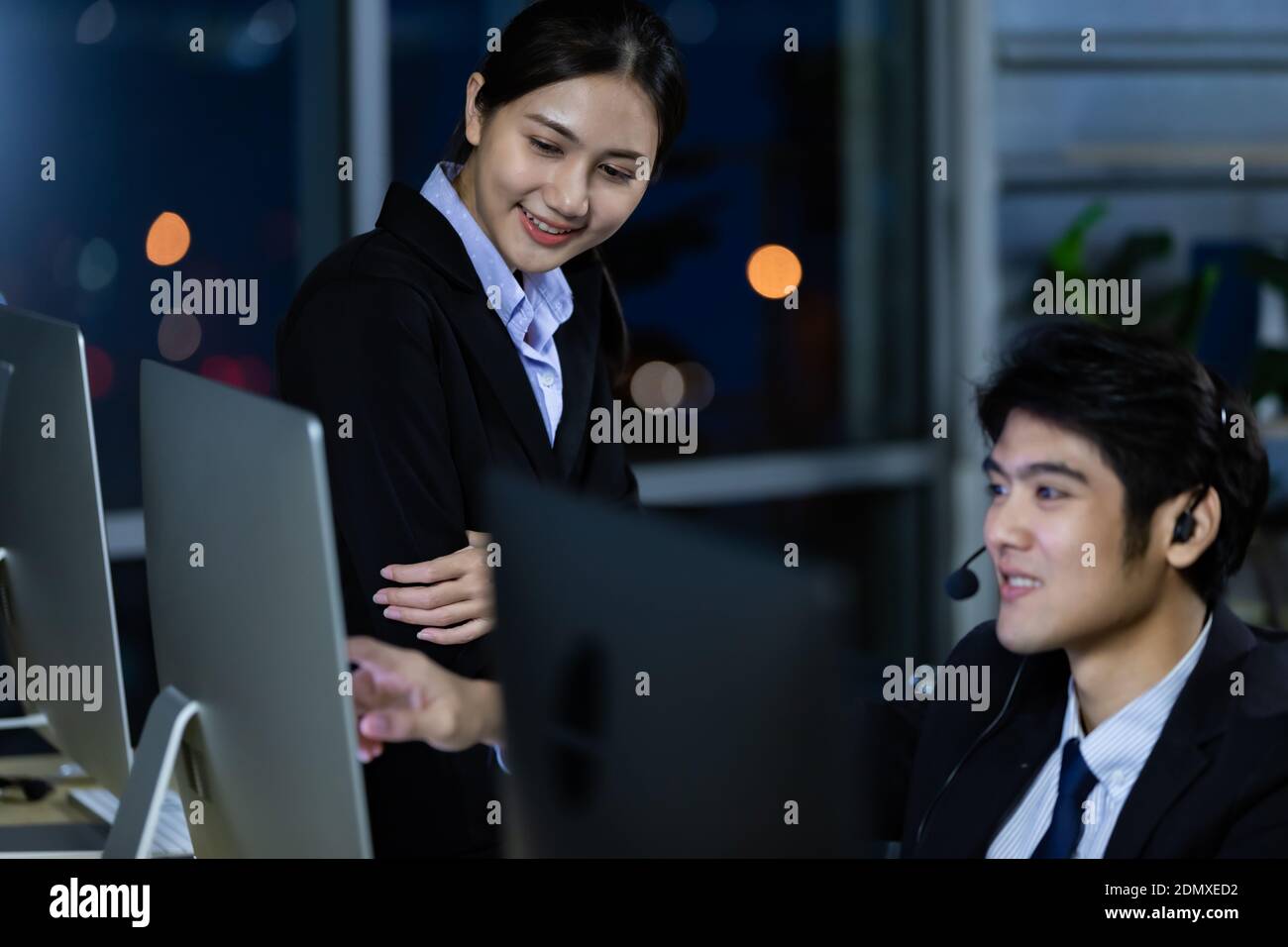Business team working overtime late at night in call center office for ...