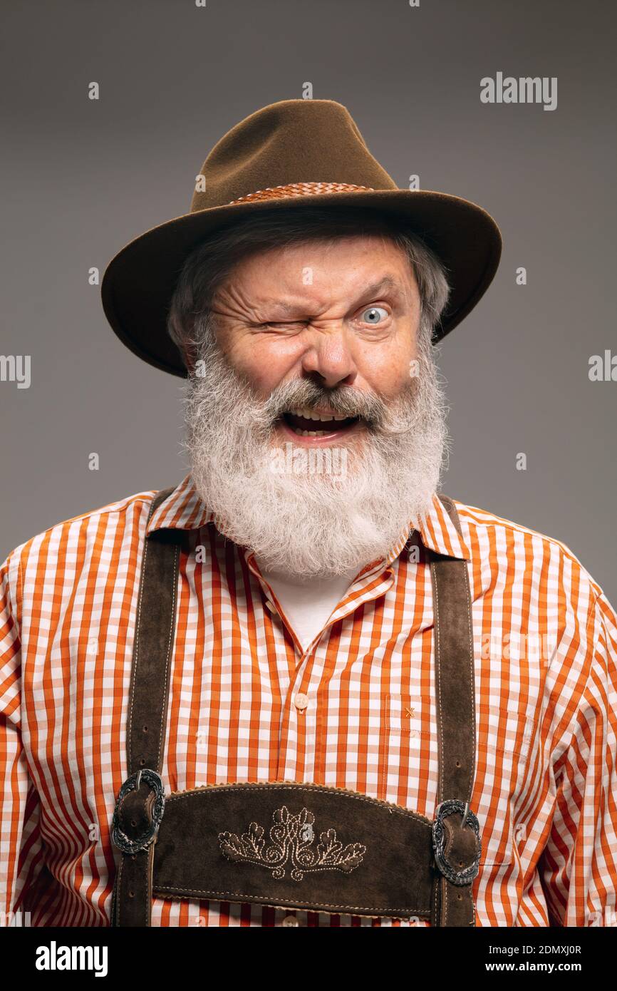Winks. Happy senior man dressed in traditional Austrian or Bavarian ...