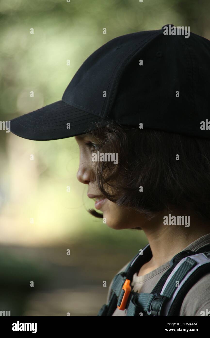 Side View Of Girl Wearing Cap Looking Away Stock Photo - Alamy