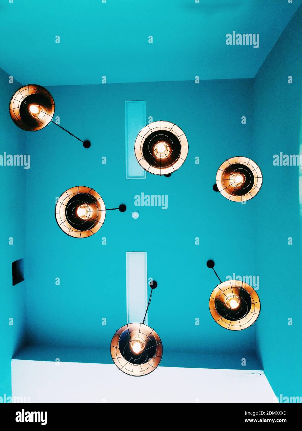 Directly Below View Of Illuminated Light Bulbs Hanging From Blue ...