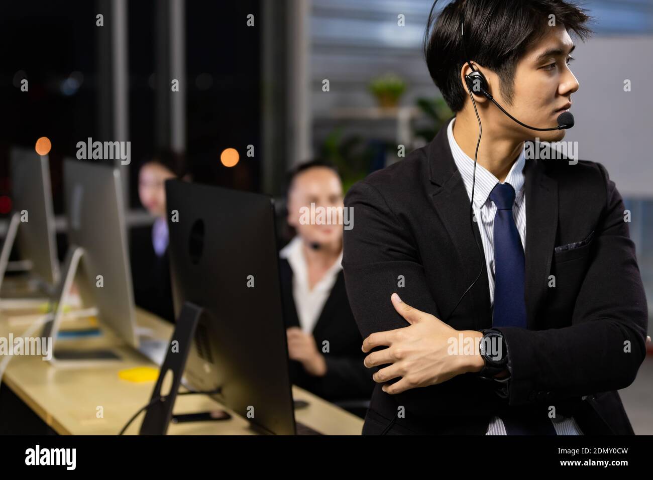 Businessman wearing headphone headset working overtime late at night in ...