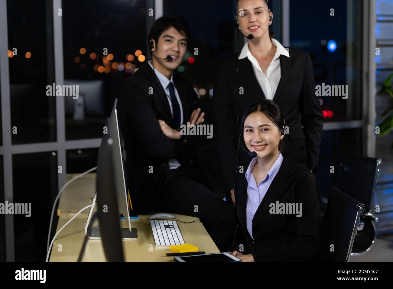 Business team working overtime late at night in call center office for ...