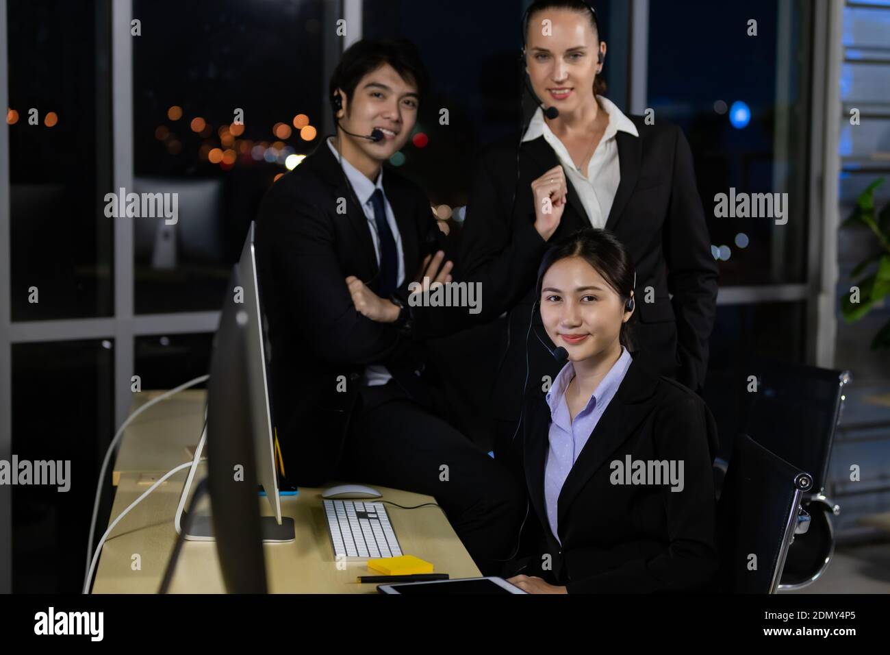 Business team working overtime late at night in call center office for ...