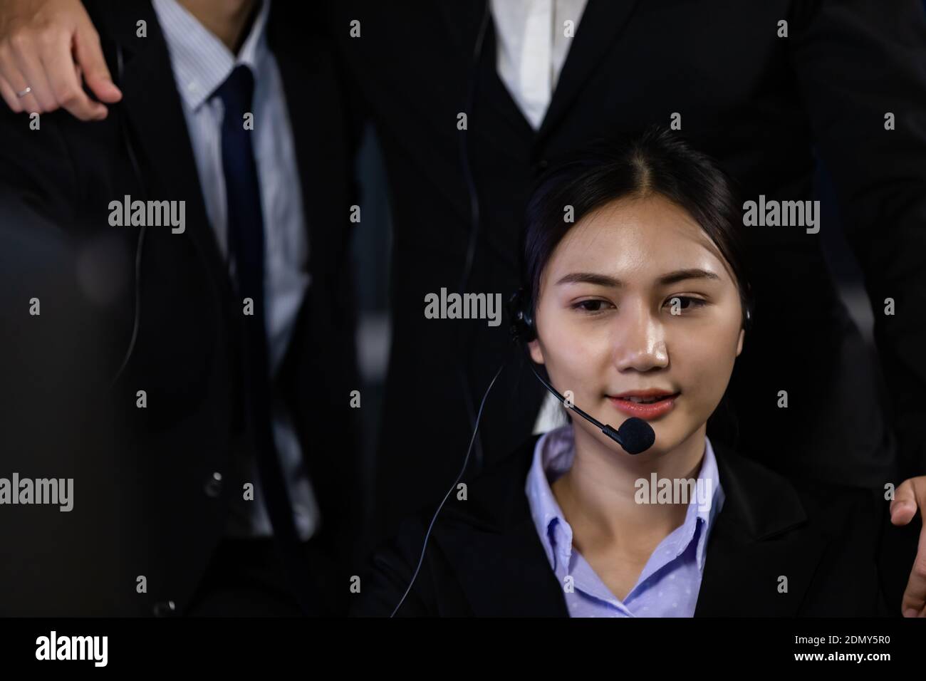 Business team working overtime late at night in call center office for ...