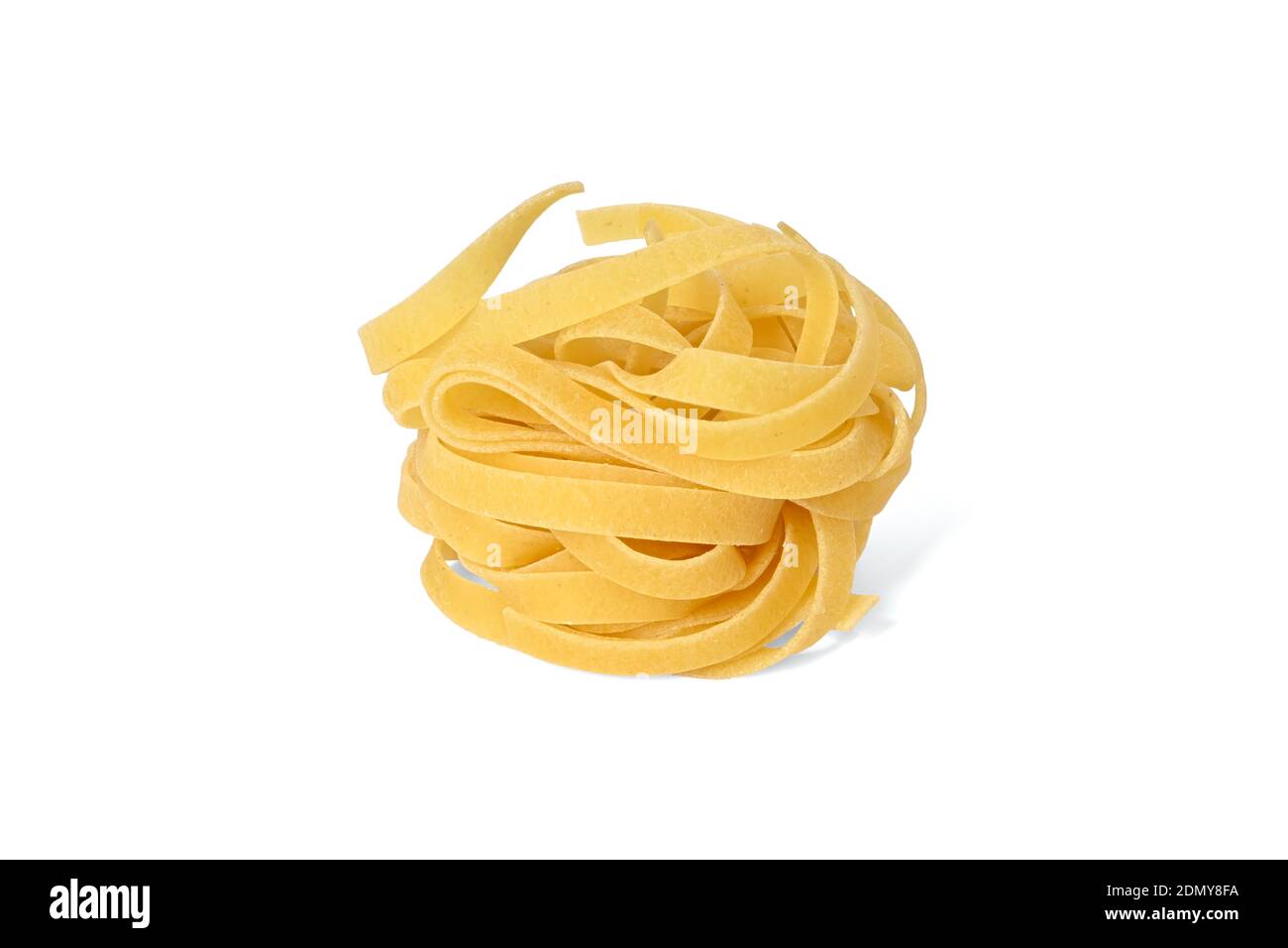Italian pasta tagliatelle, raw and uncooked. Basic ingredient in the ...