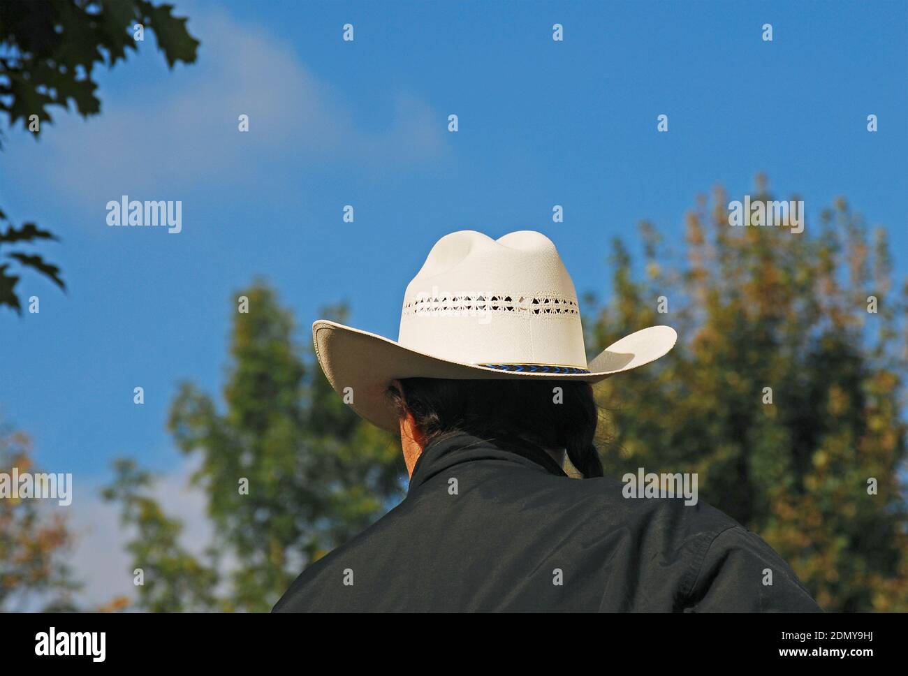 rear view of a young woman with cowboy hat Stock Photo - Alamy