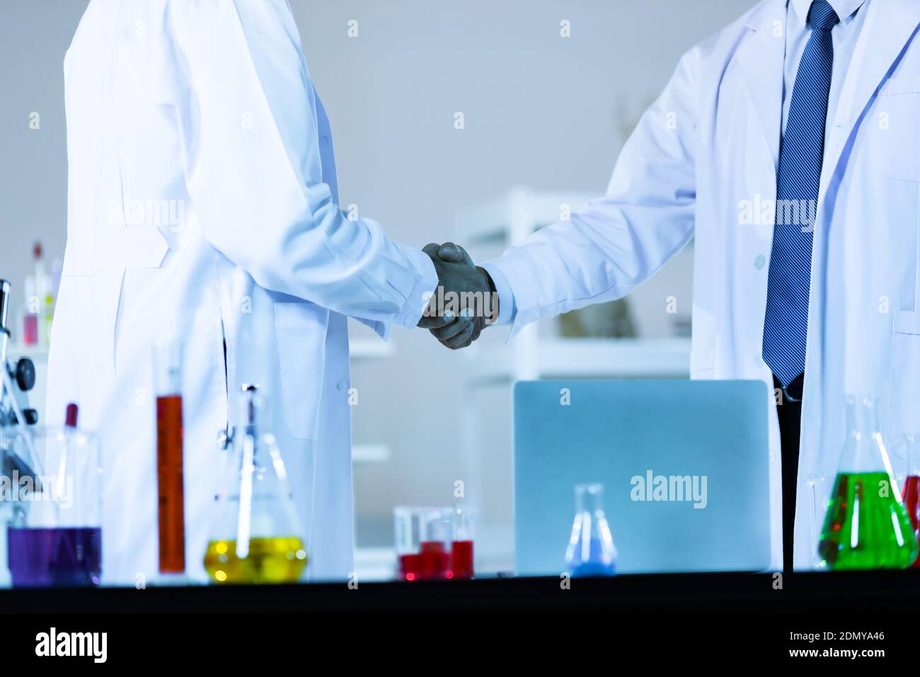 Two scientists shaking hands positivity success happiness. Concept ...