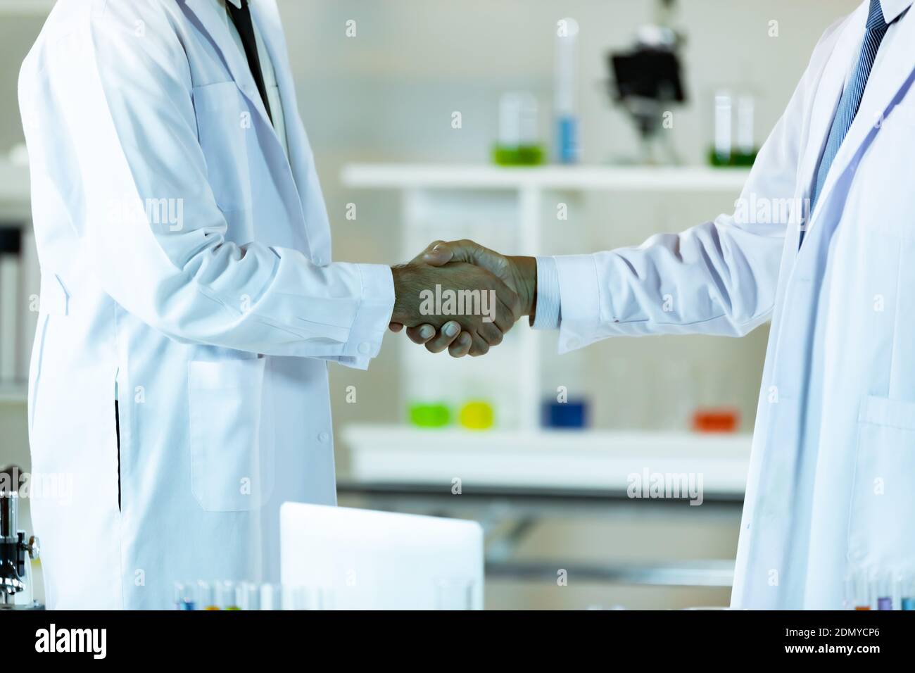 Two scientists shaking hands positivity success happiness. Concept ...