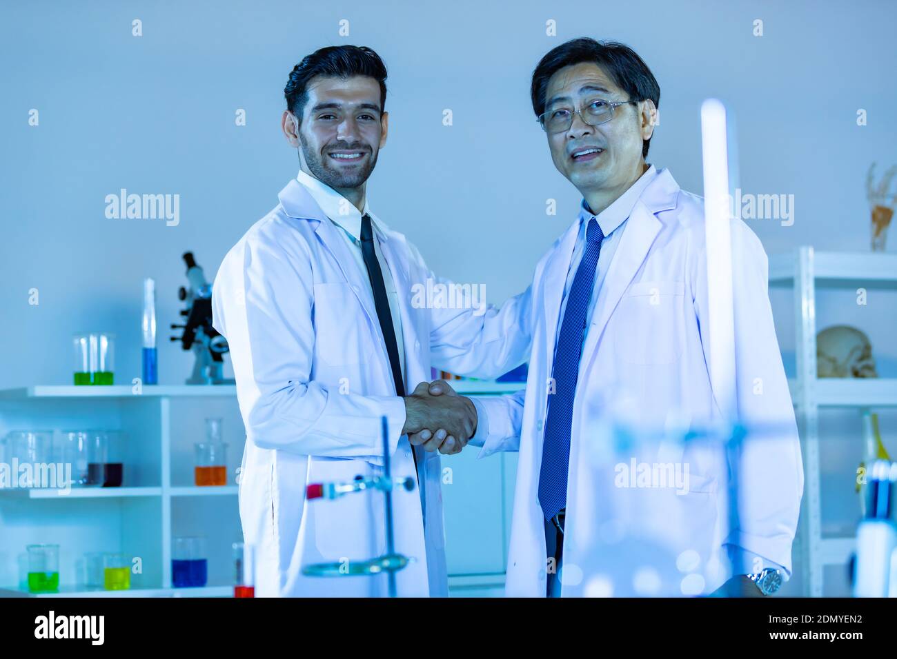 Two scientists shaking hands positivity success happiness. Concept ...