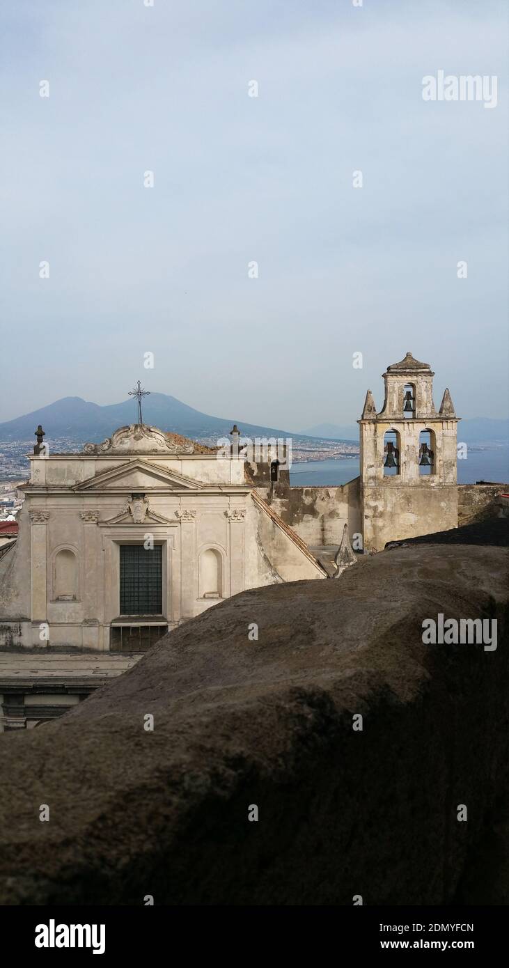 The clock of the Sant'Elmo castle in Naples, with the Vesuvius behind ...