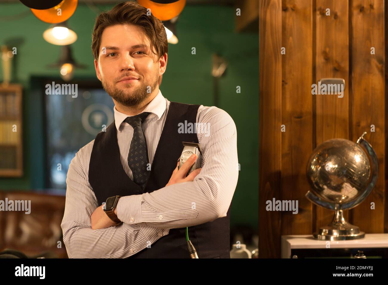 Happy handsome professional barber smiling to the camera standing at ...