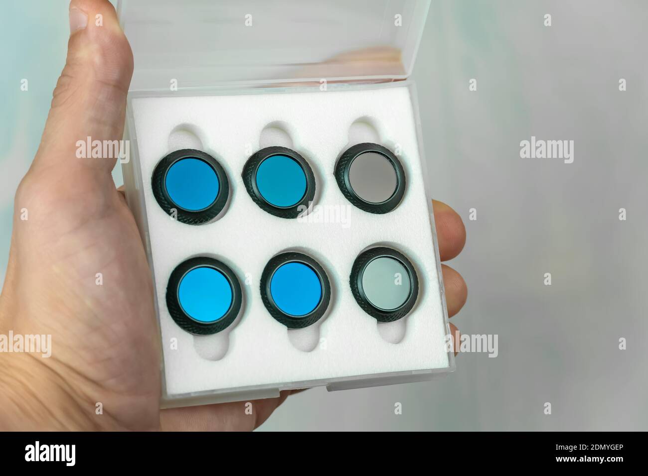 Box with filters for the drone camera in the hand of a man close-up ...