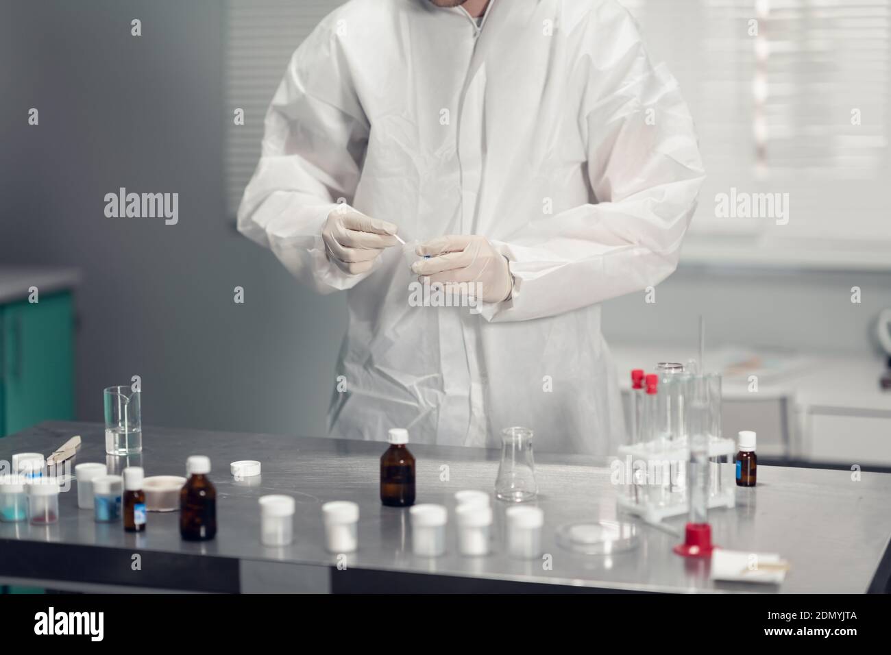 Pharmacy laboratory. A scientist mixes a liquid form of medication in a ...