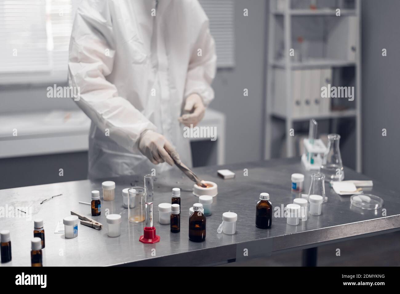 Chemical laboratory in action. A scientific researcher setting on fire ...