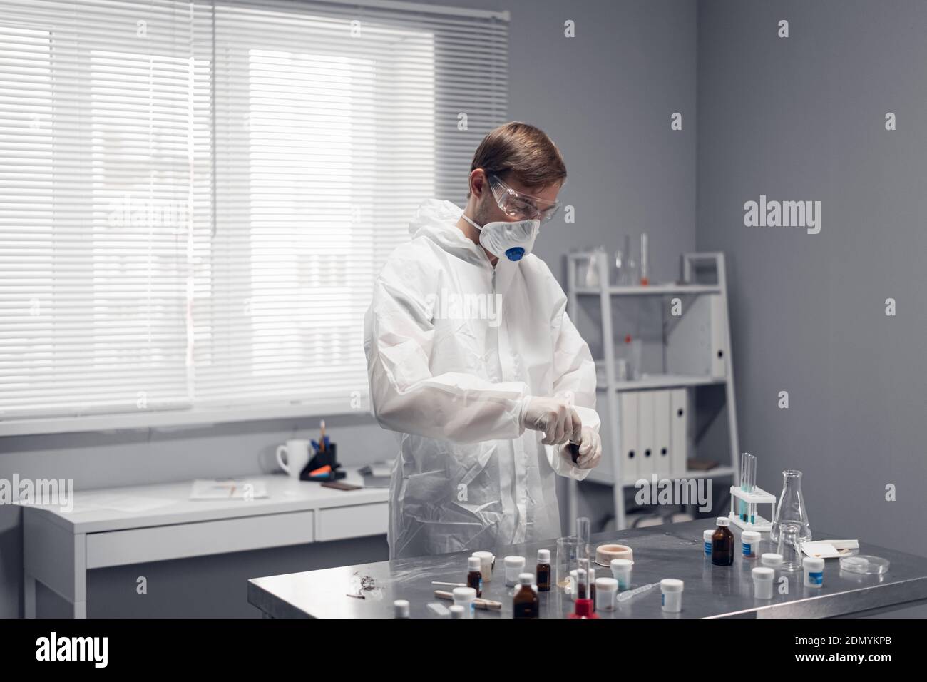 Male lab technician holding a test sample in the medical or scientific ...