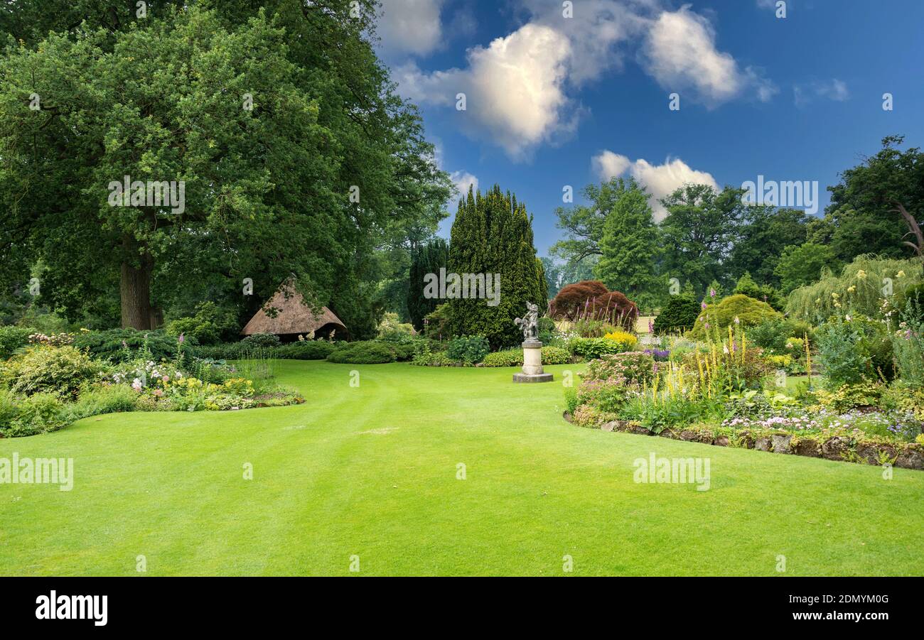 big green garden with green grass flowers and gardenhouse Stock Photo ...