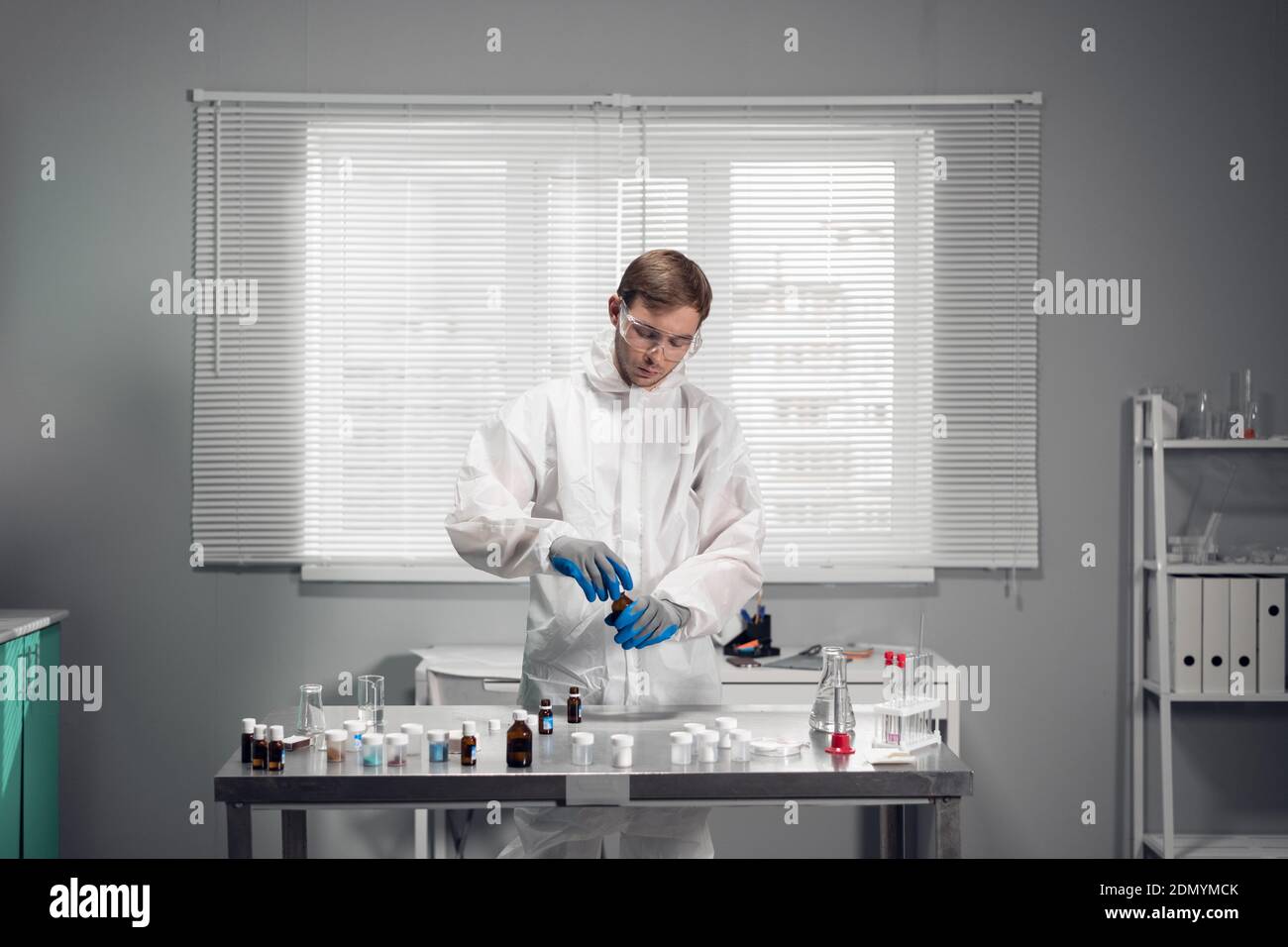 A male scientist testing some chemical in a science Laboratory. Science ...