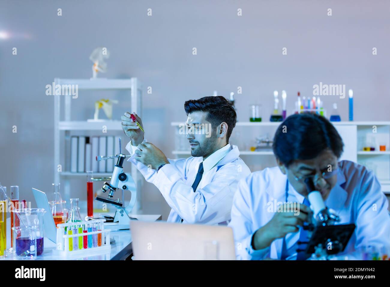 Team of research scientists analysing test trial new generation vaccine ...