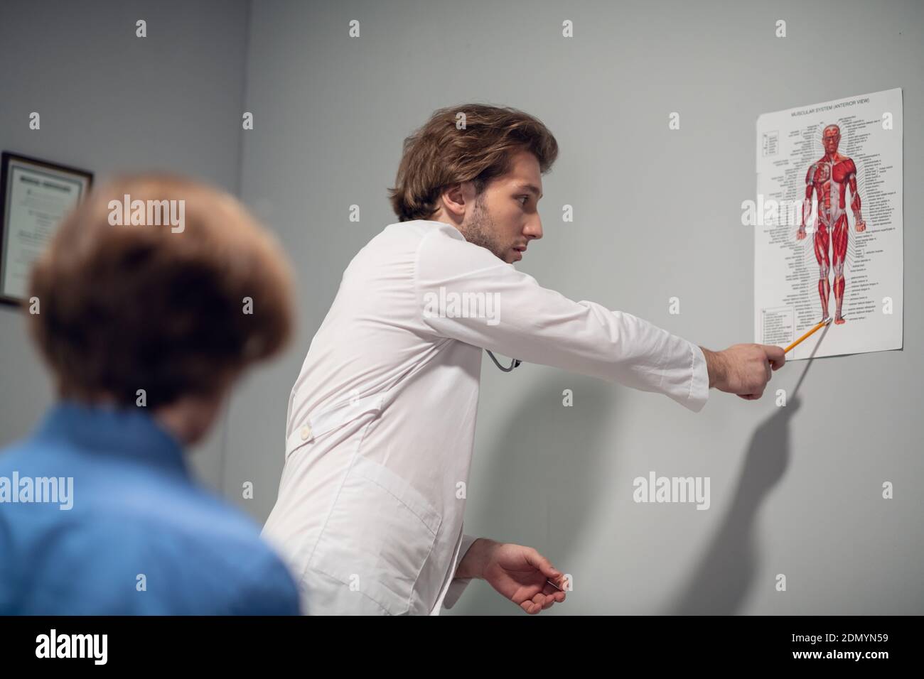 A doctor is explaining something to his patient, using the picture ...