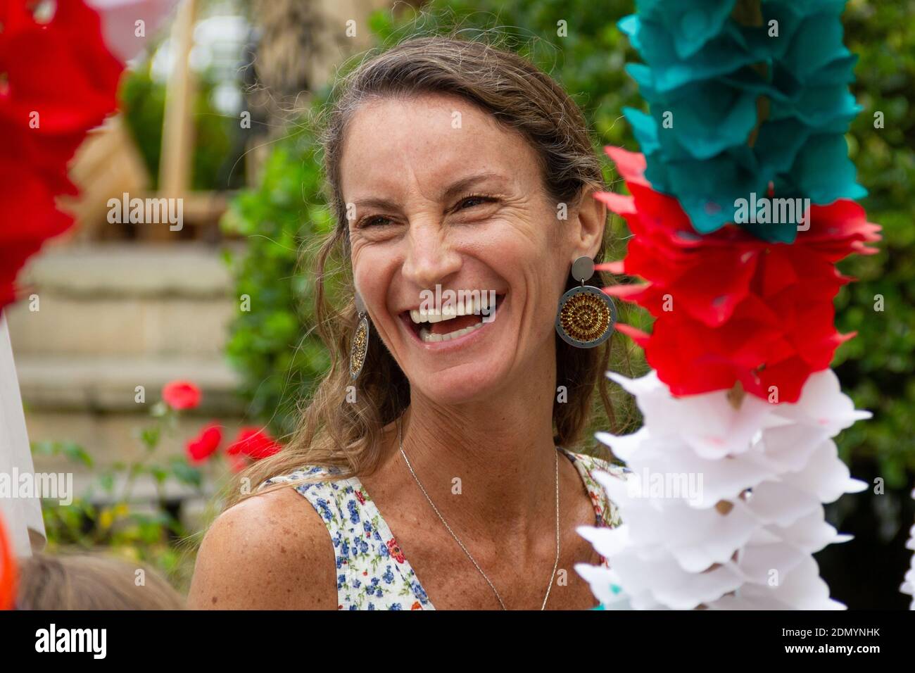 Pretty middle aged woman laughing while holding traditional Basque ...