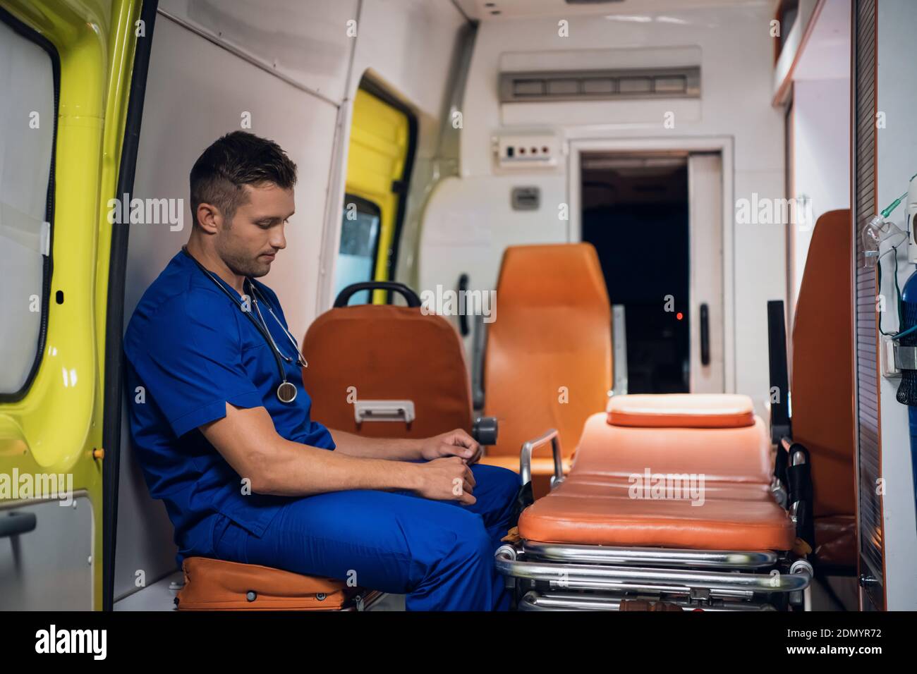 Tired and sad paramedic sitting in an ambulance car Stock Photo - Alamy