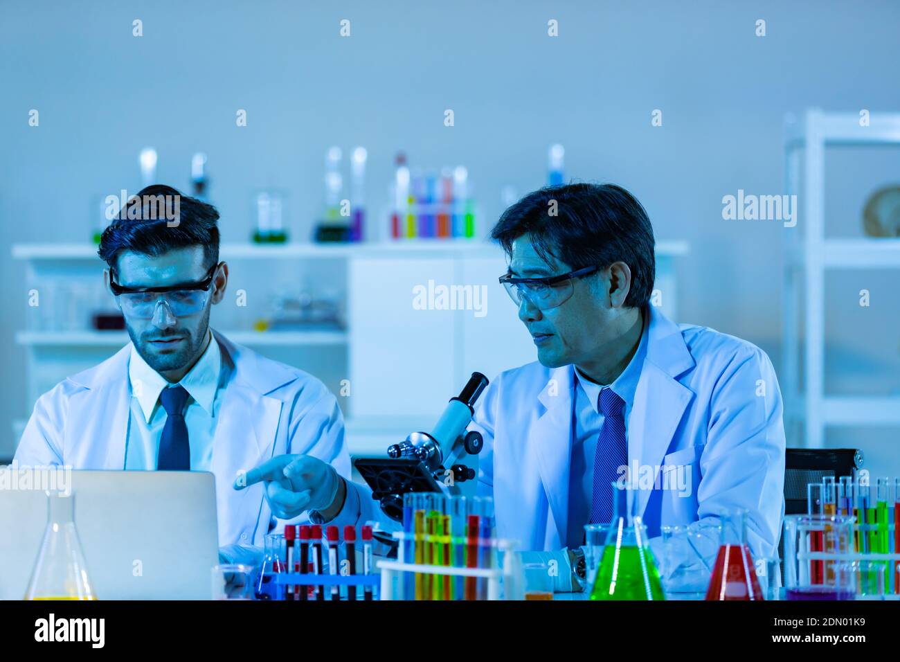 Team of research scientists analysing test trial new generation vaccine ...