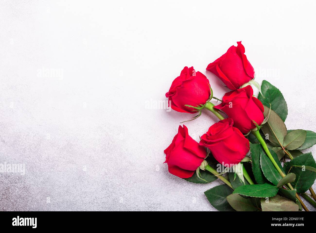 Red roses flowers on stone background. Valentine's greeting card. Top ...
