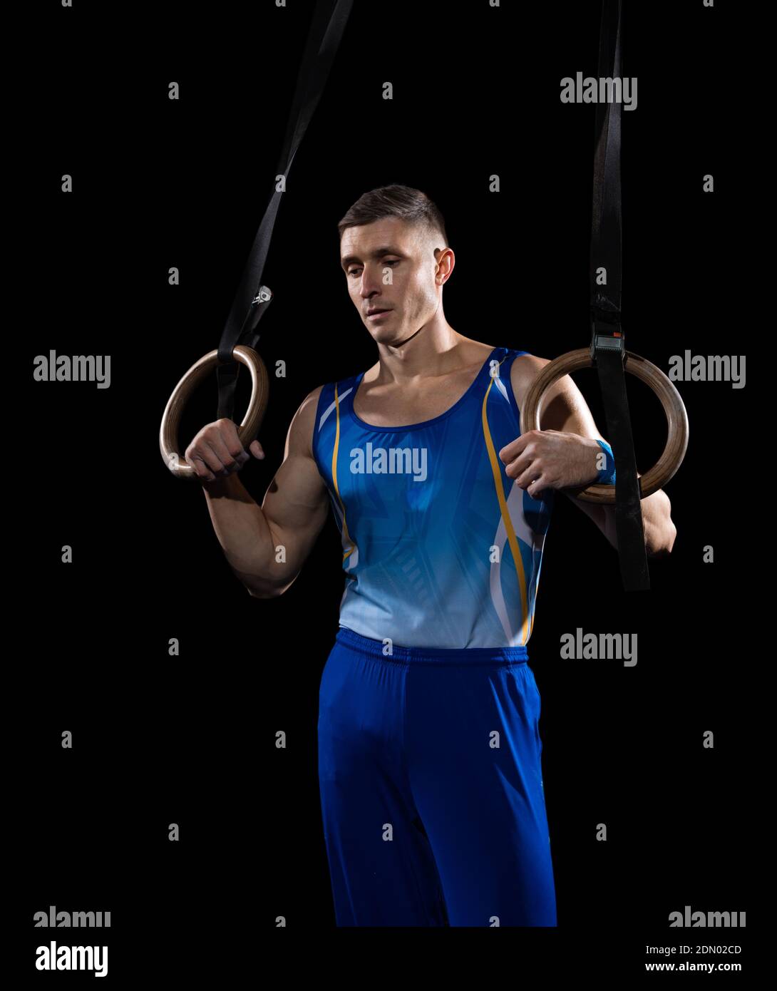 Strong. Muscular male gymnast training in gym, flexible and active ...