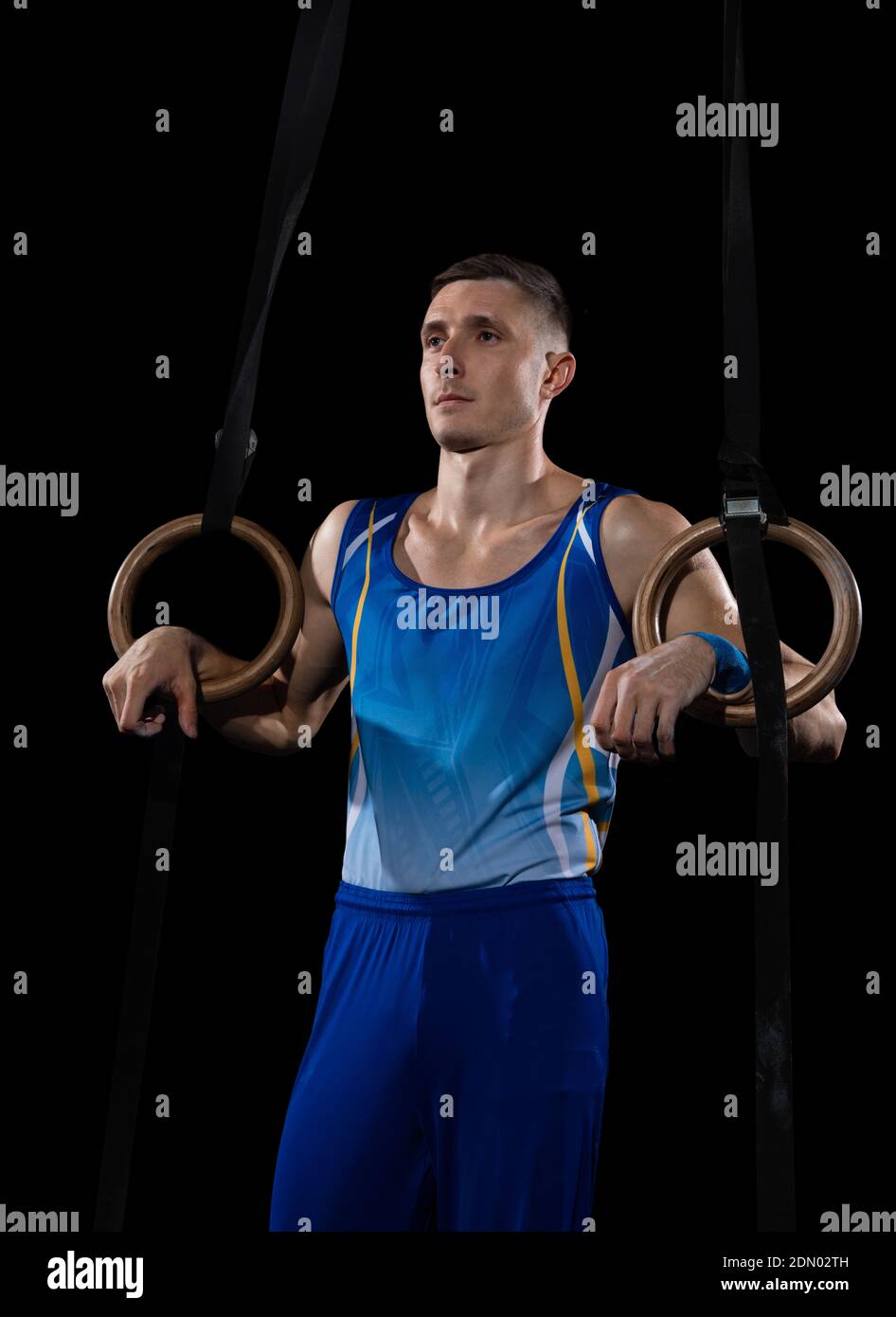 Strong. Muscular male gymnast training in gym, flexible and active ...