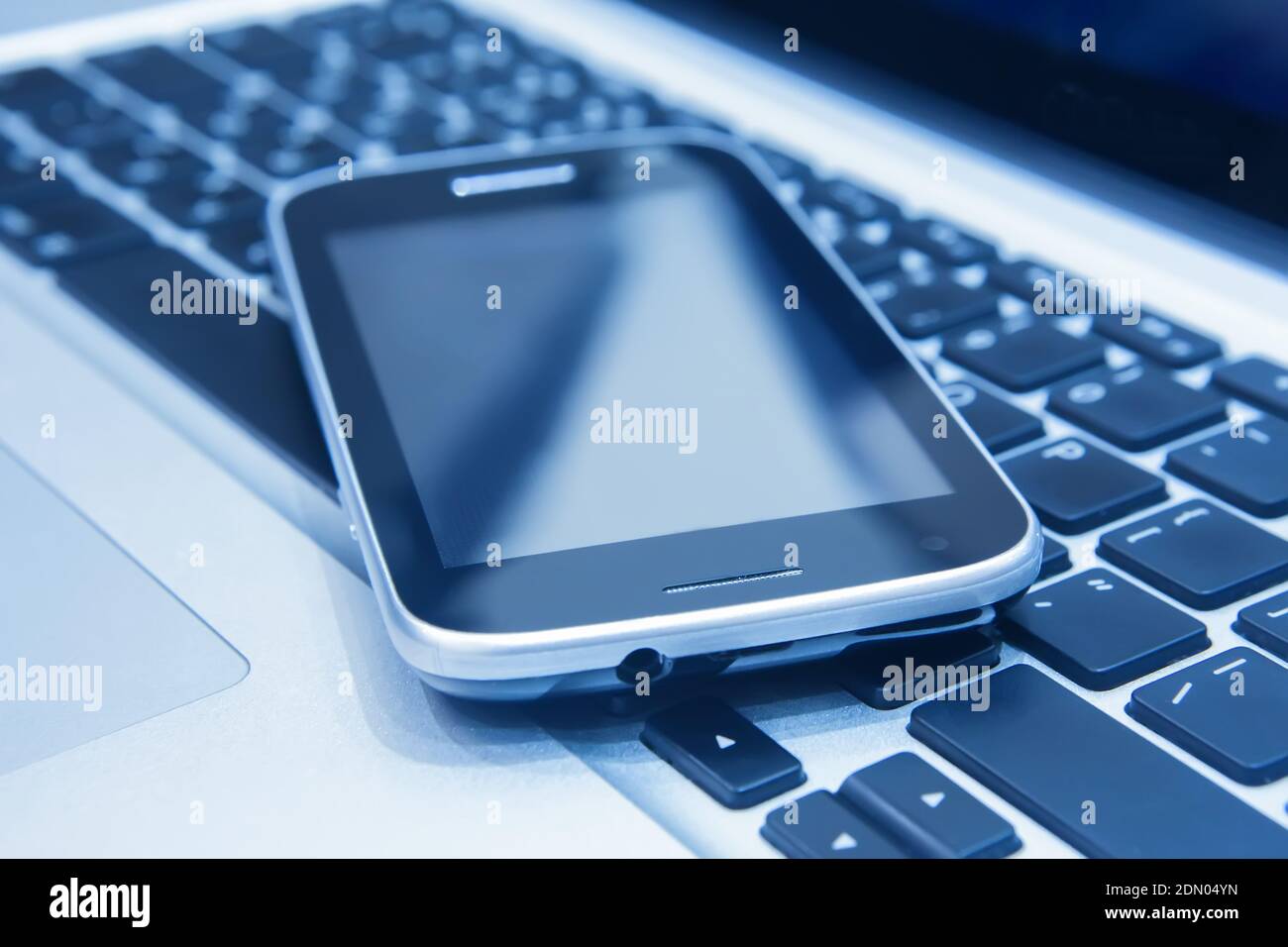 modern smartphone on the computer keyboard Stock Photo - Alamy