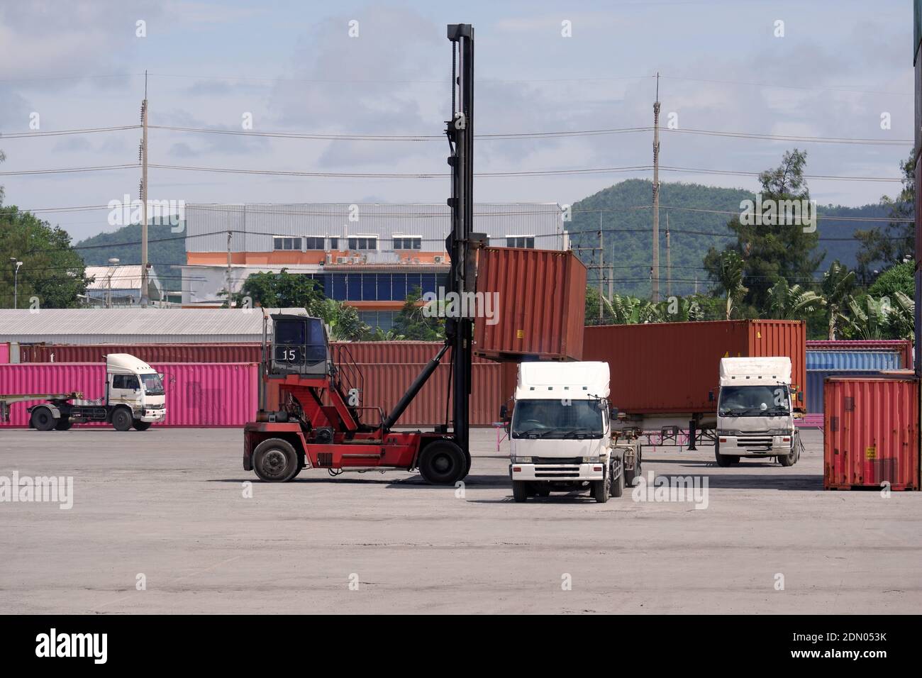Forklift crane transports container boxes to trucks in the logistics ...