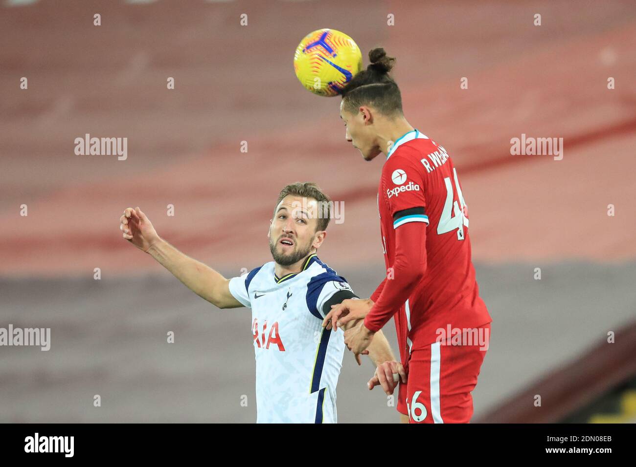 Rhys Williams #46 of Liverpool heads the ball as Harry Kane #10 of ...