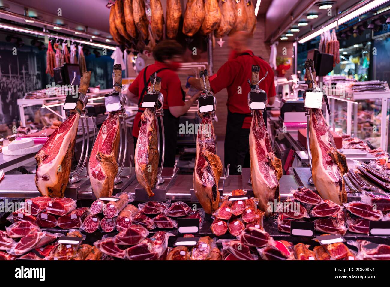 Big variety of traditional spanish jamon ham in butchers shop at a ...