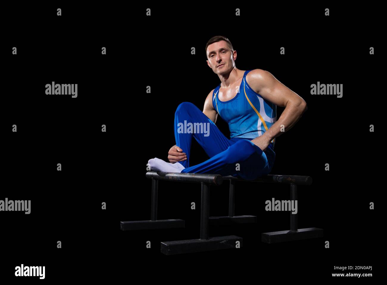 Inspired. Muscular male gymnast training in gym, flexible and active ...
