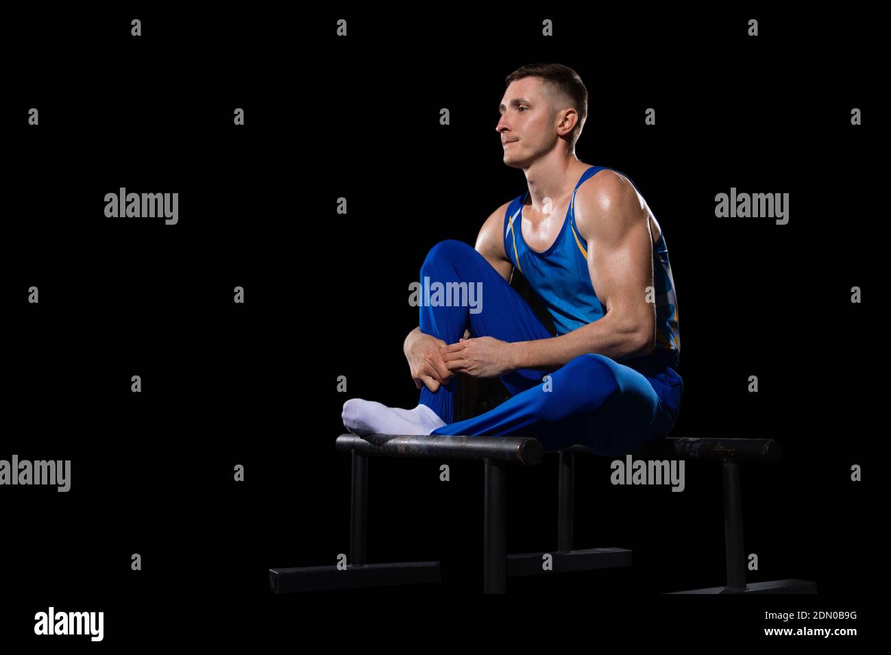 Inspired. Muscular male gymnast training in gym, flexible and active ...