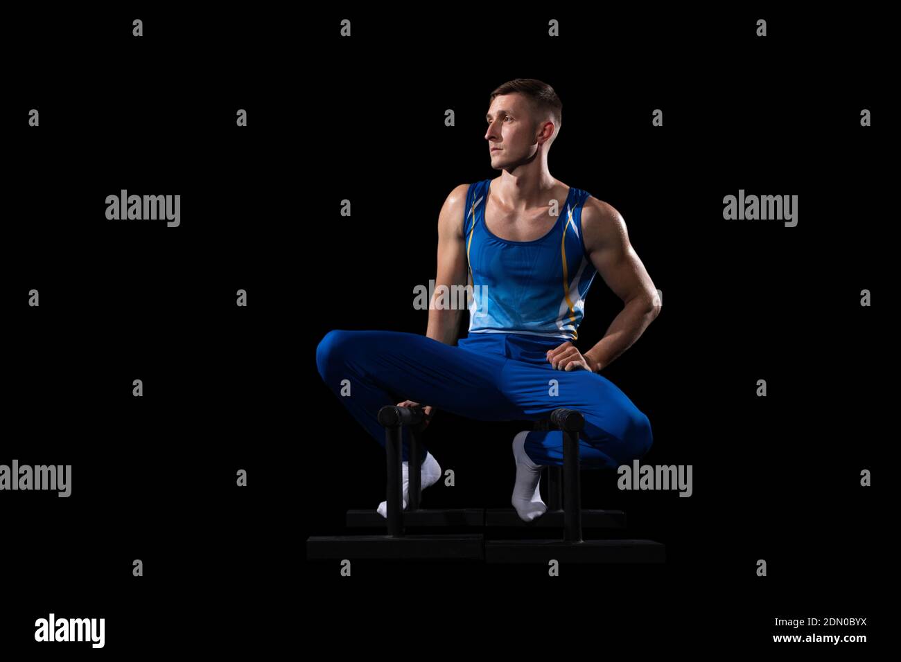 Target. Muscular male gymnast training in gym, flexible and active ...