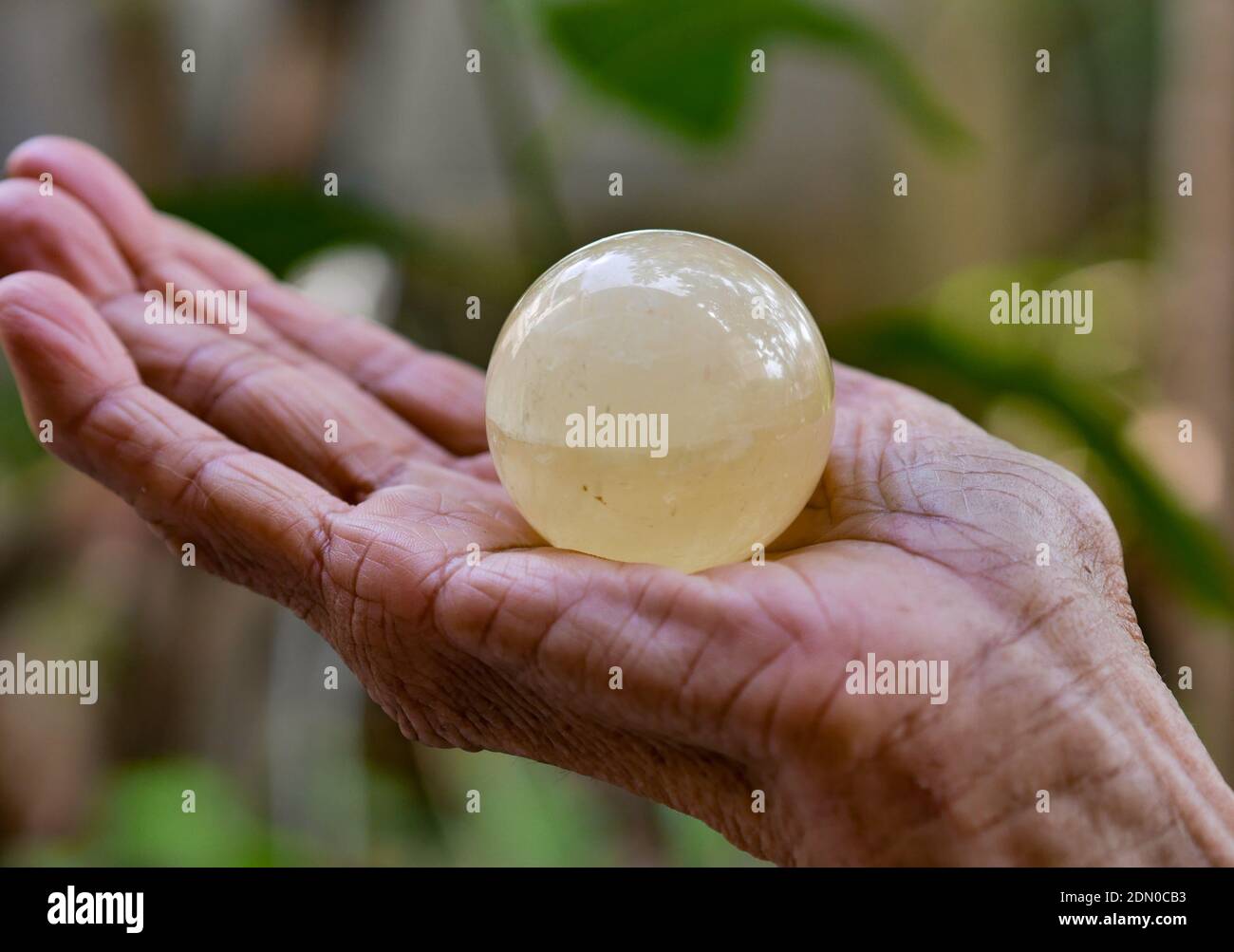 Hands holding marbles hi-res stock photography and images - Alamy