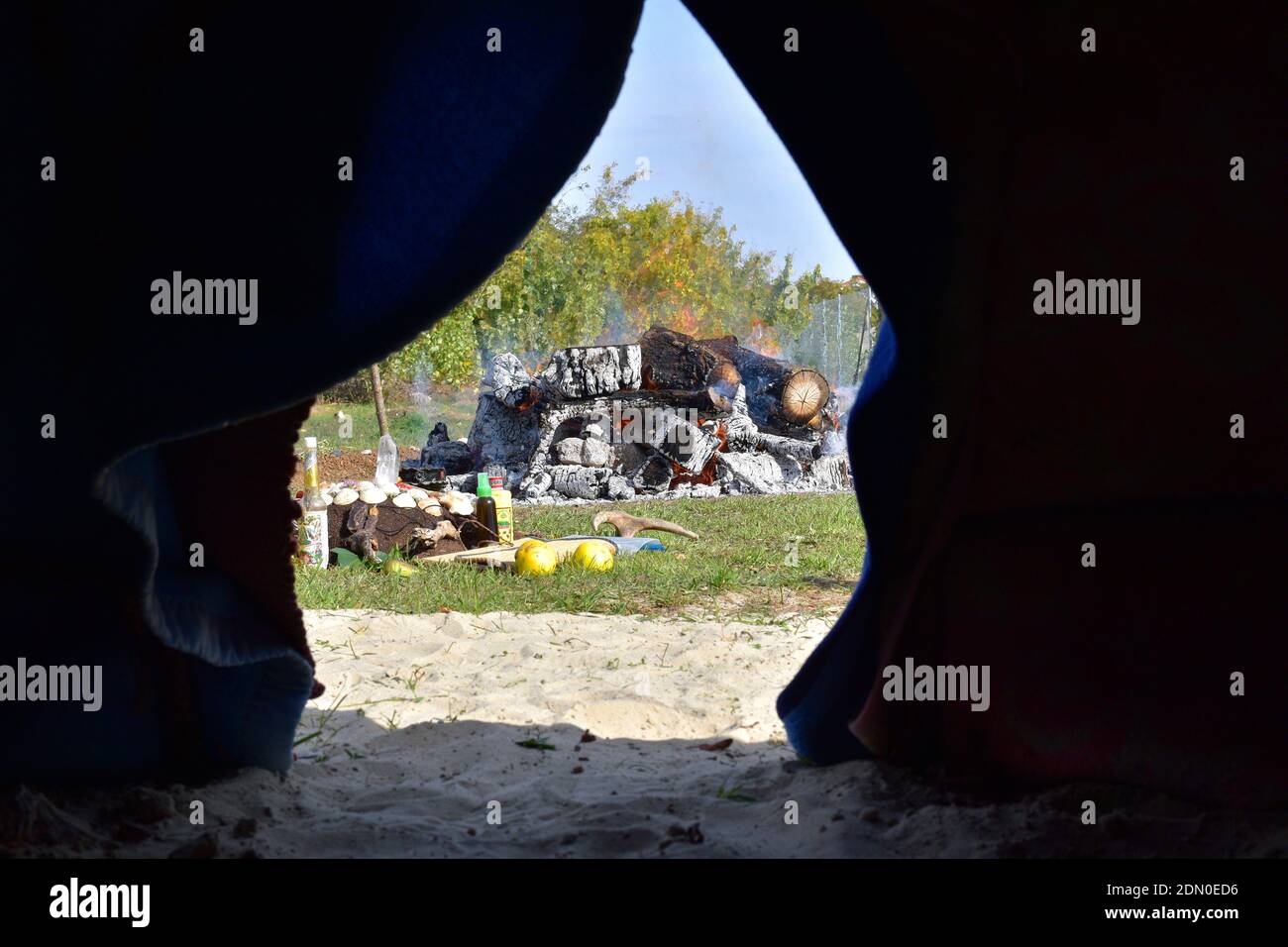 View from inside the inipi of the bonfire and offerings Stock Photo - Alamy