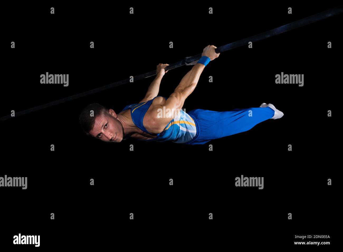 Professional. Muscular male gymnast training in gym, flexible and ...