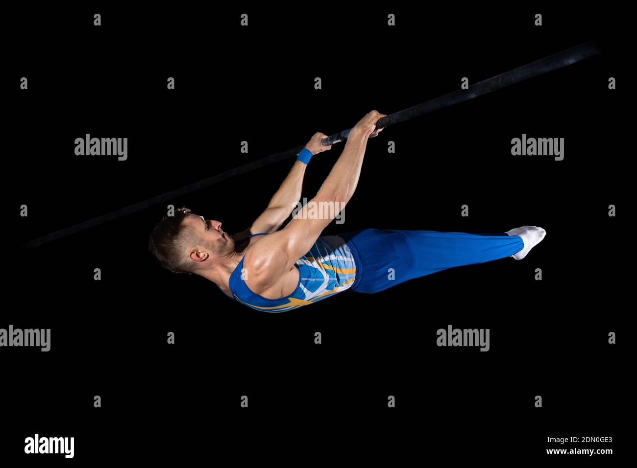 Flying. Muscular male gymnast training in gym, flexible and active ...