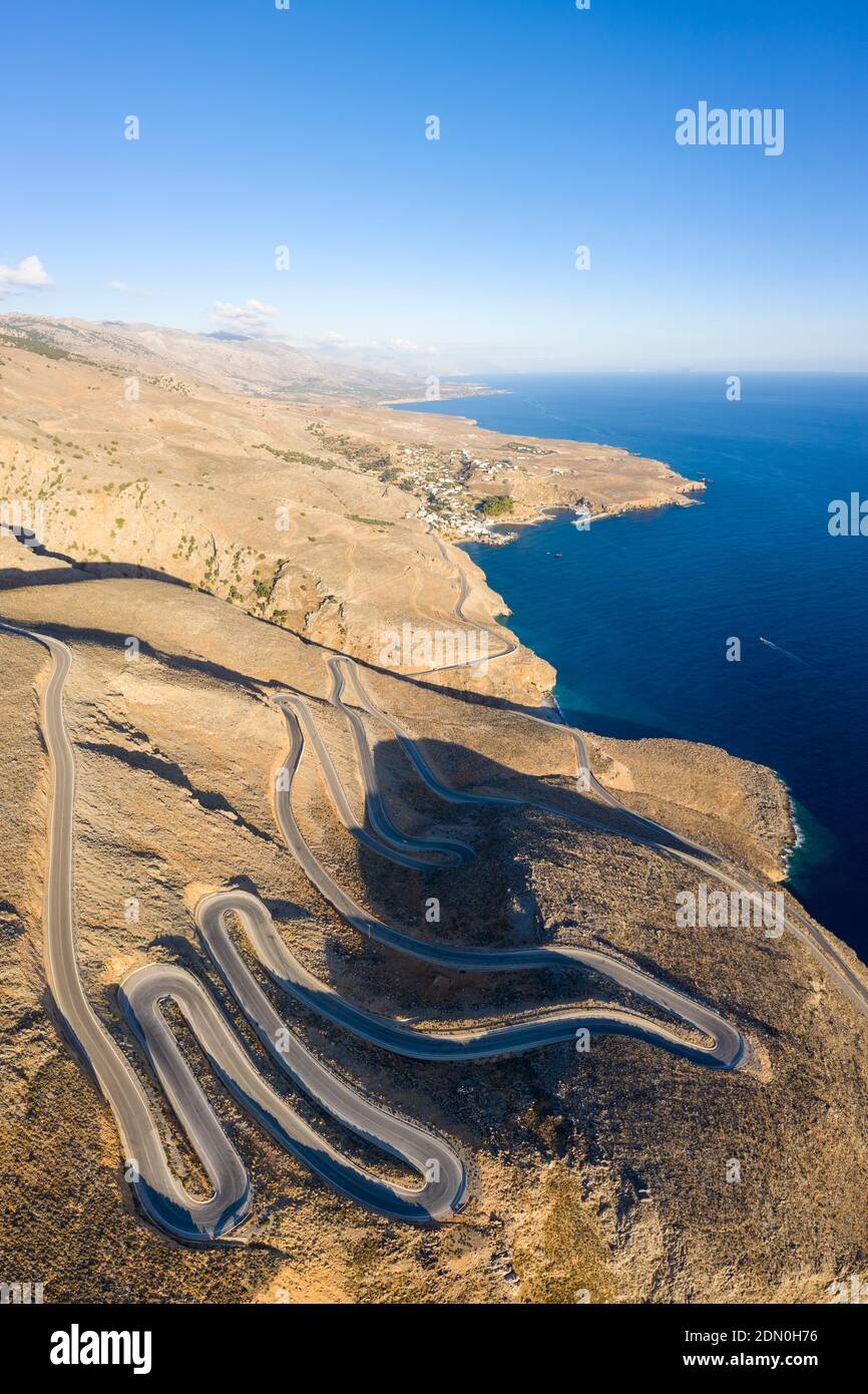 Aerial coastal view of the winding road between the towns of Hora ...