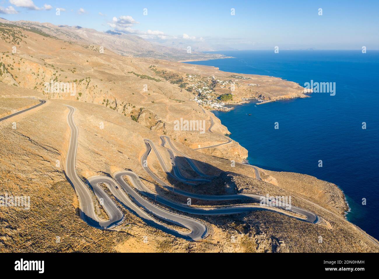 Aerial coastal view of the winding road between the towns of Hora ...